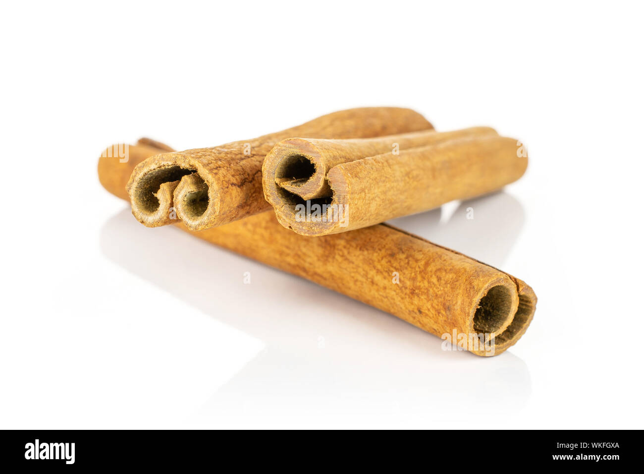 Group of three whole dry brown cinnamon isolated on white background ...