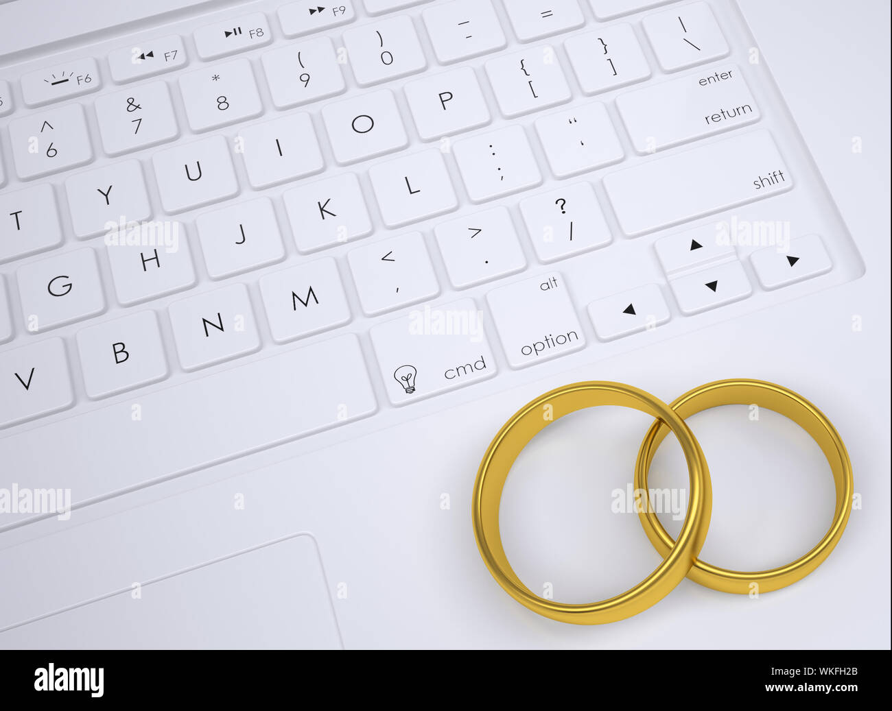 Two gold rings on the keyboard. View from above Stock Photo - Alamy