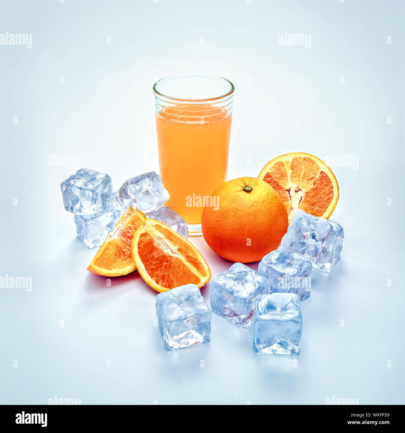 Glass of cool orange juice, ice and orange slices in he composition Stock Photo - Alamy