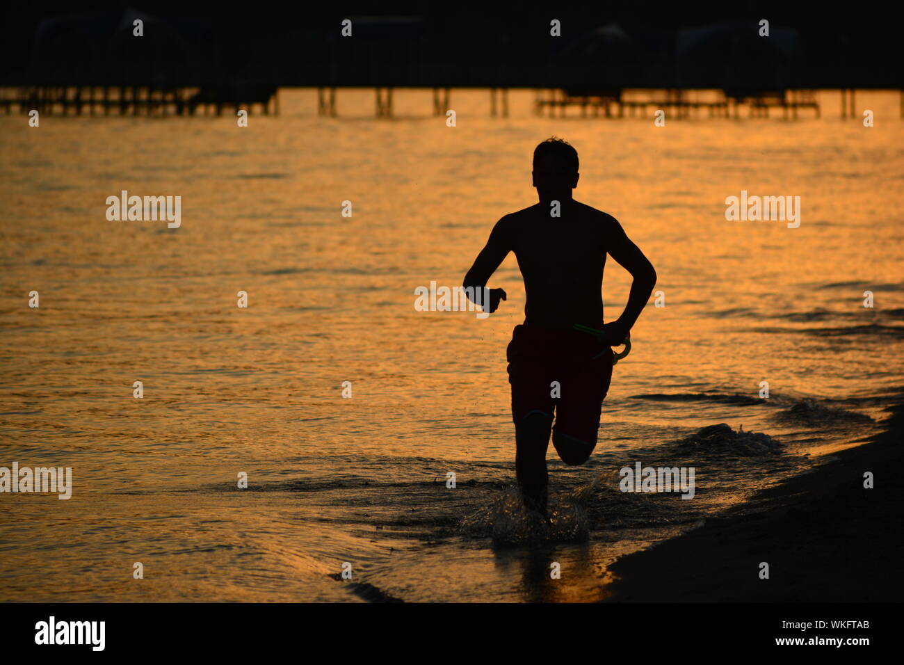 Man running in sea hi-res stock photography and images - Alamy