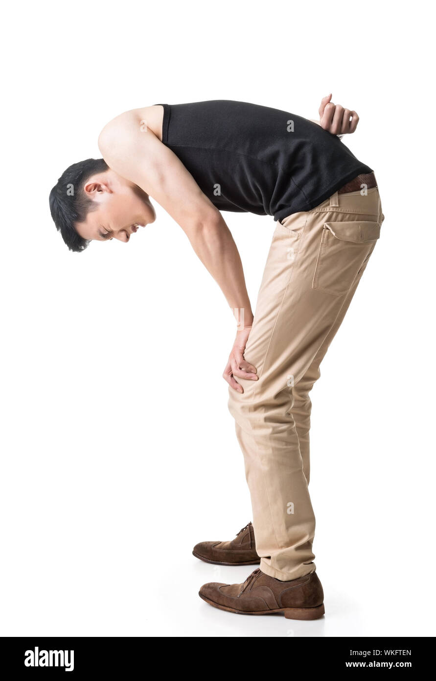 Asian young man with back pain, full length portrait isolated on white ...