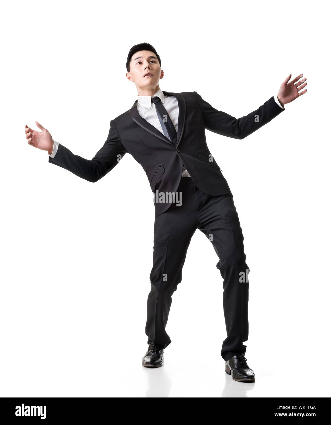 Asian business surprised with outrageously pose, full length portrait ...