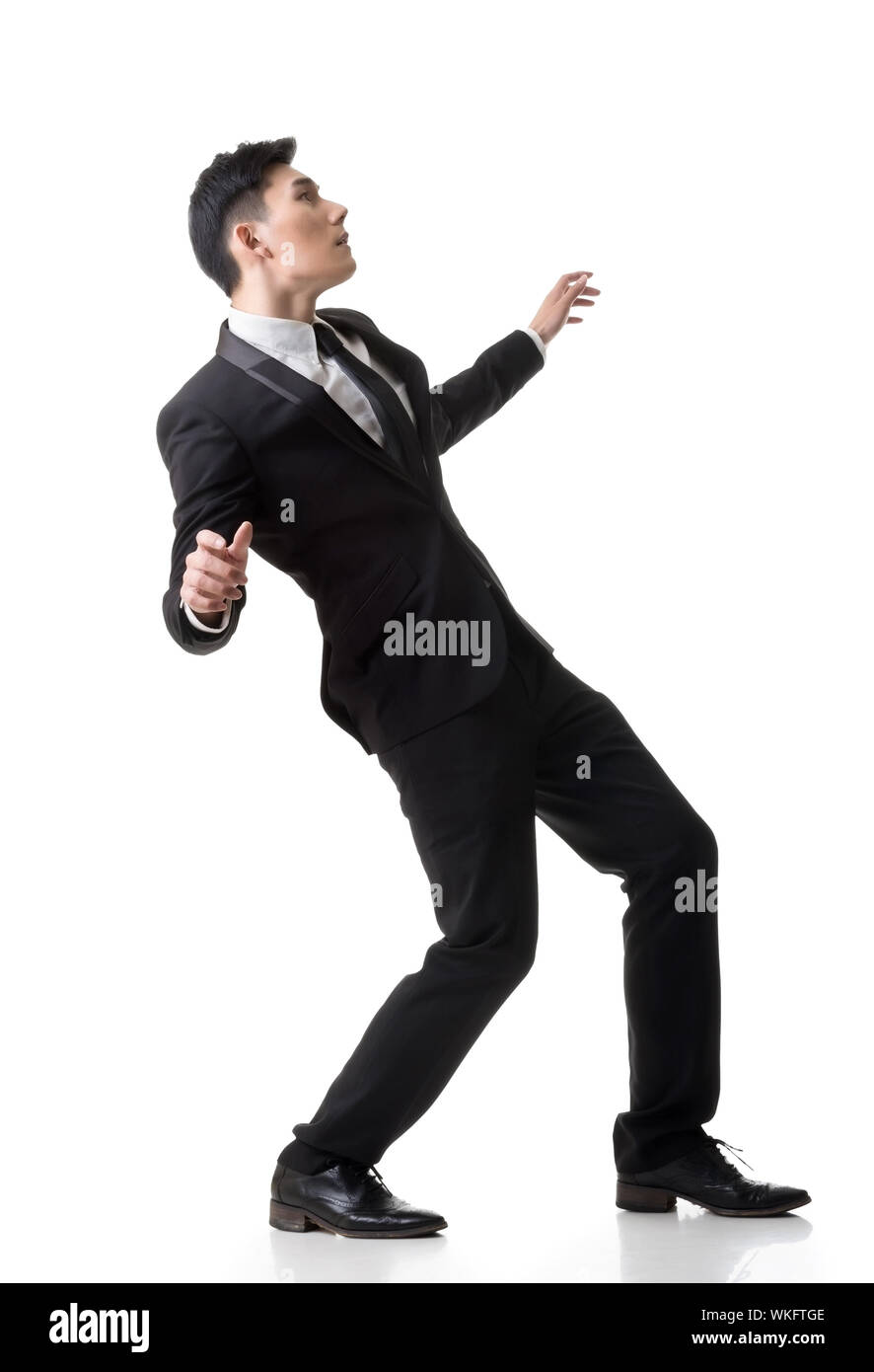 Asian business surprised with outrageously pose, full length portrait ...