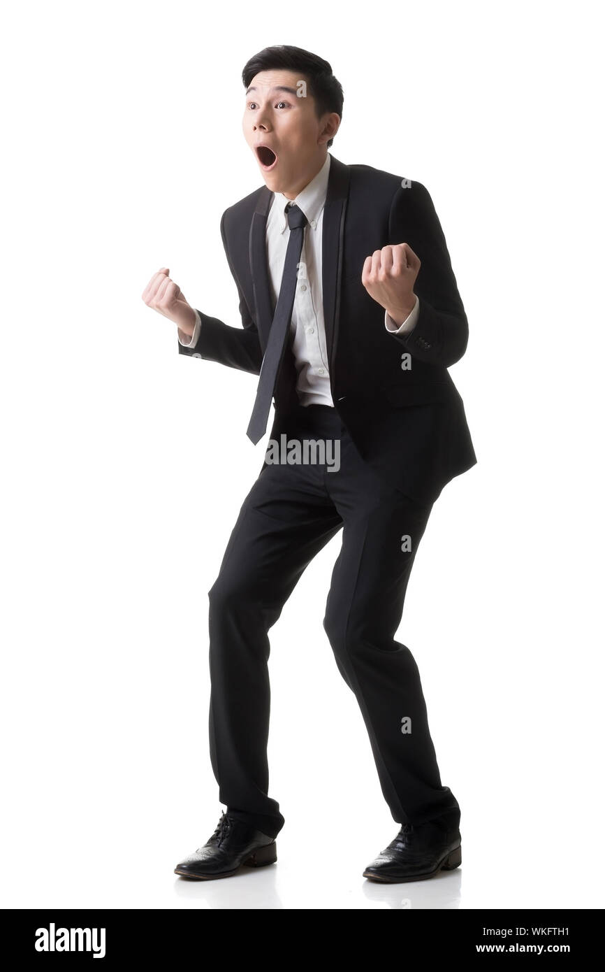 Asian business surprised with outrageously and funny pose, full length ...
