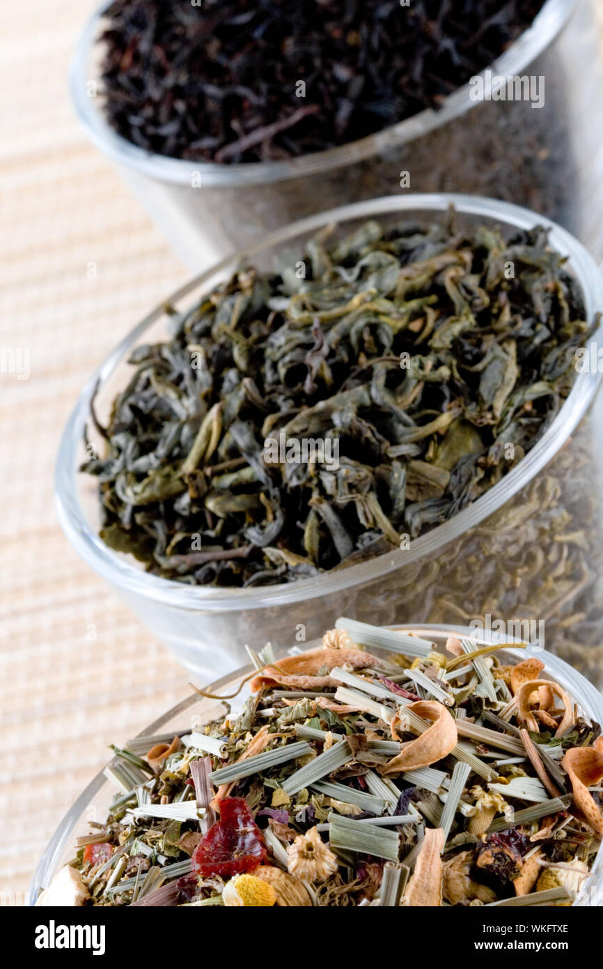three kinds of dry tea in glasses closeup on straw background Stock ...
