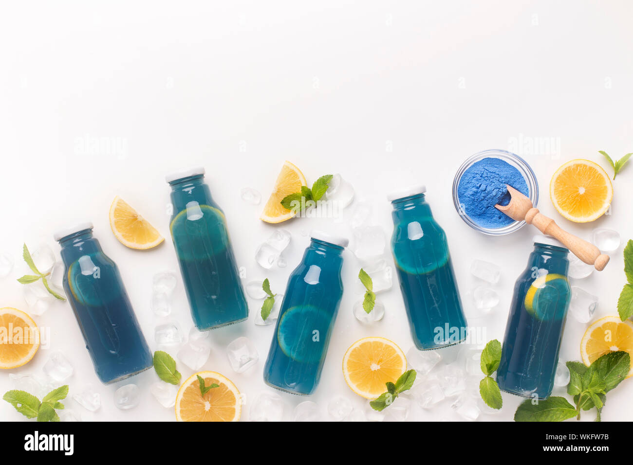 Set of blue detox bottles with fresh lemon slices inside on white Stock ...
