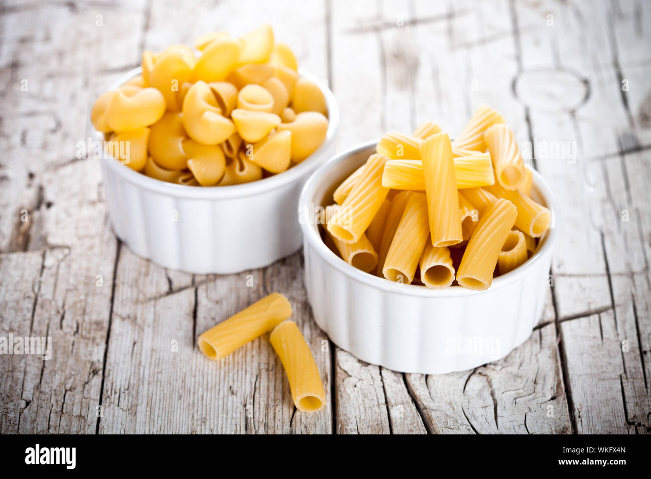 uncooked pasta in two bowls on rustic wooden background Stock Photo - Alamy