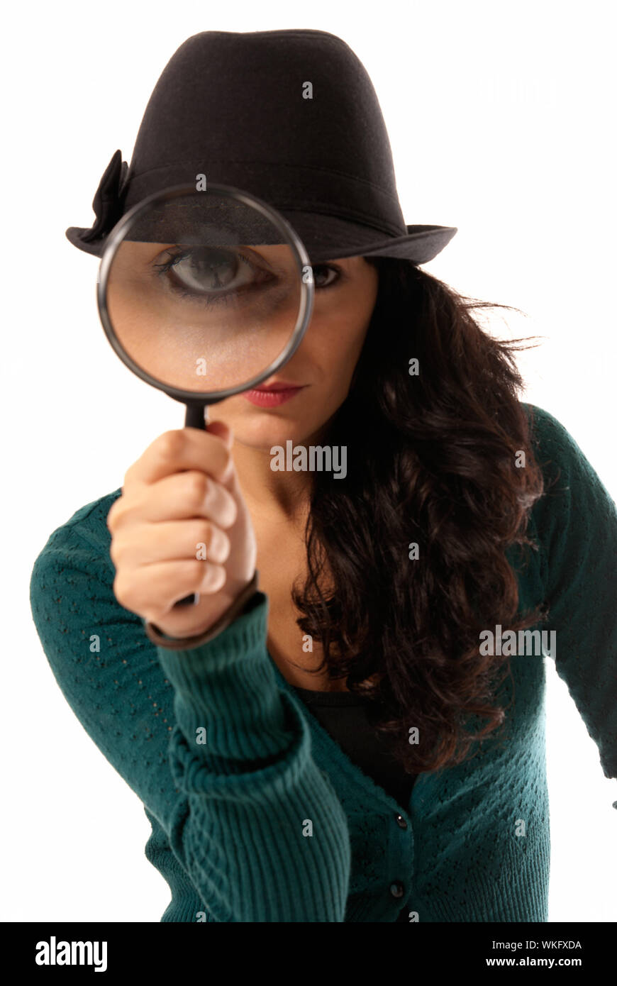 Young woman looking through magnifying glass loupe detective isolated ...