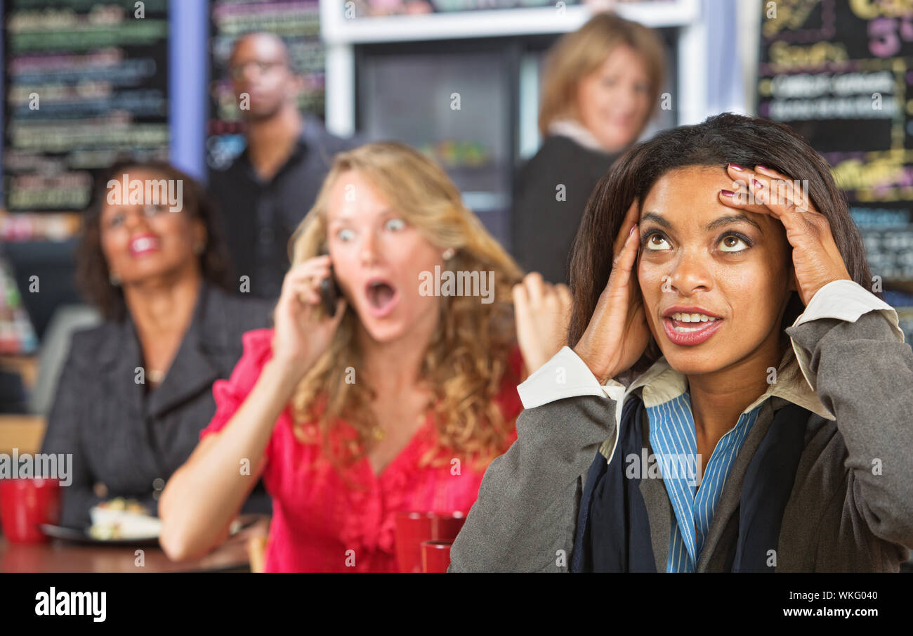 Annoyed lady listening to obnoxious woman on phone Stock Photo - Alamy