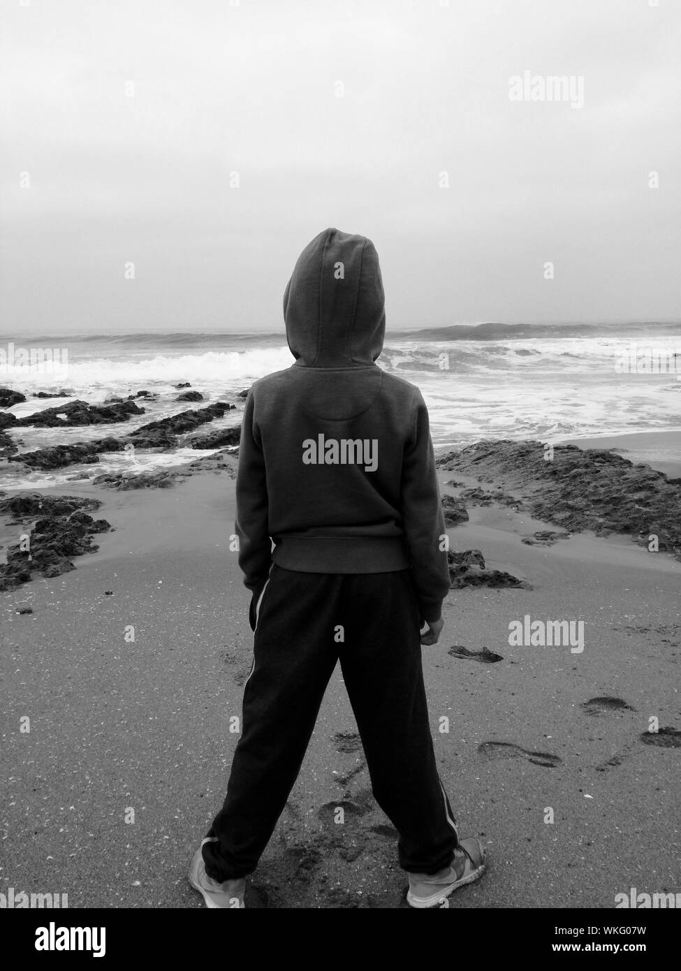 Boy standing rear view Black and White Stock Photos & Images - Alamy