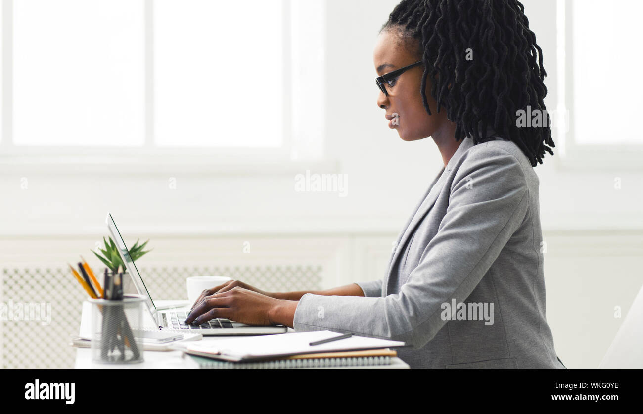 Black Office Girl Typing On Laptop Computer Sitting In Office Stock ...