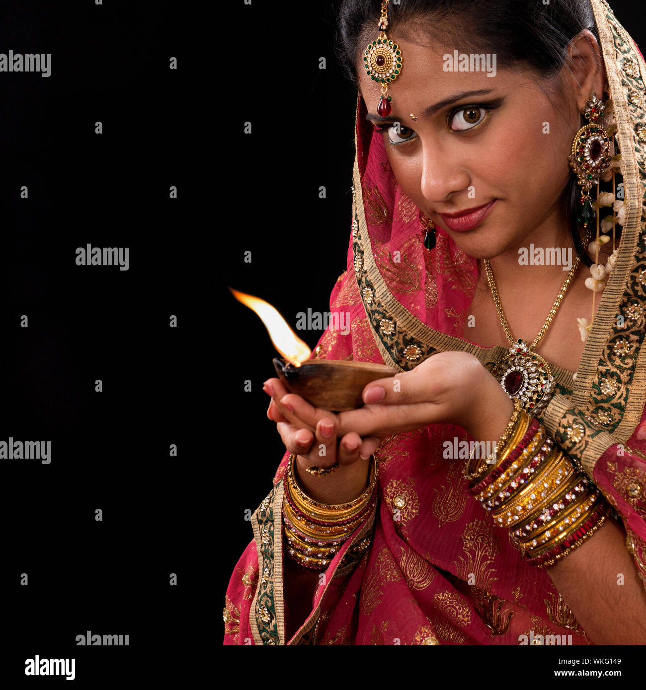 Girl holding diya hi-res stock photography and images - Alamy