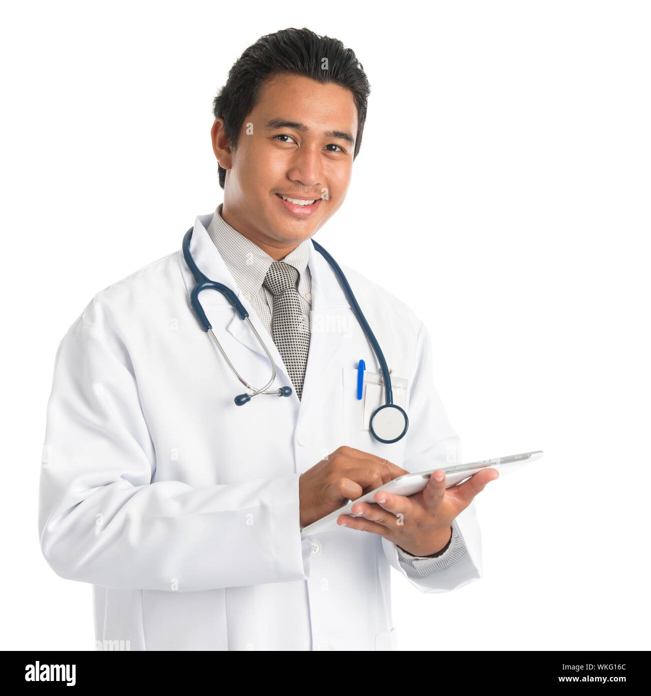 Portrait of southeast Asian male medical doctor using digital tablet ...