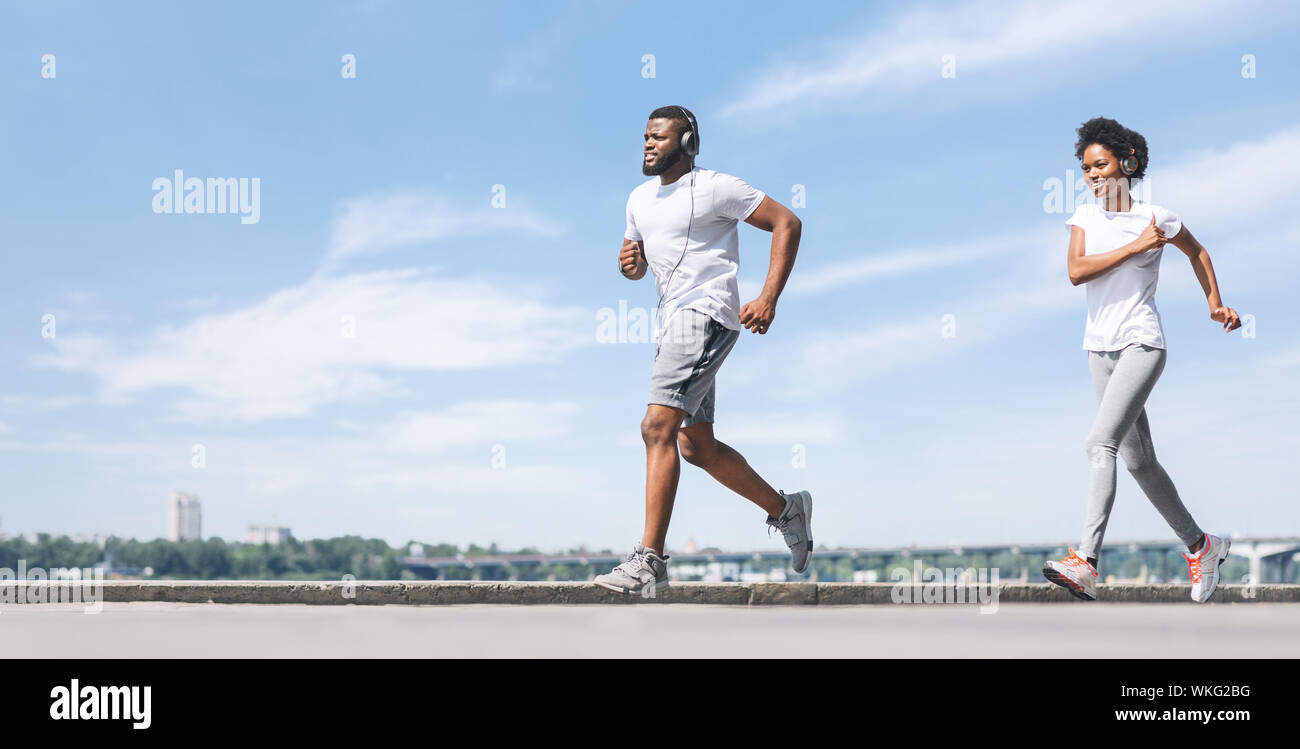 Woman jogging along river bank hi-res stock photography and images - Alamy
