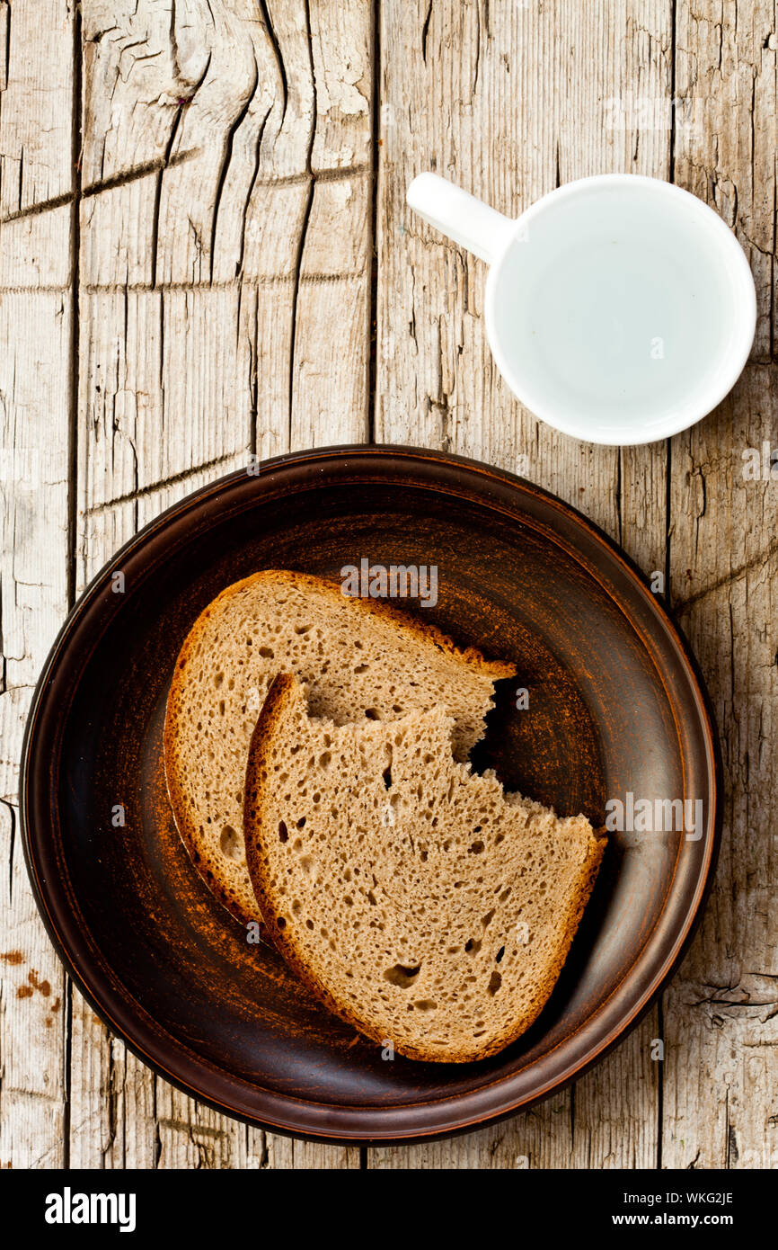 bread and water on rustic wooden background Stock Photo - Alamy