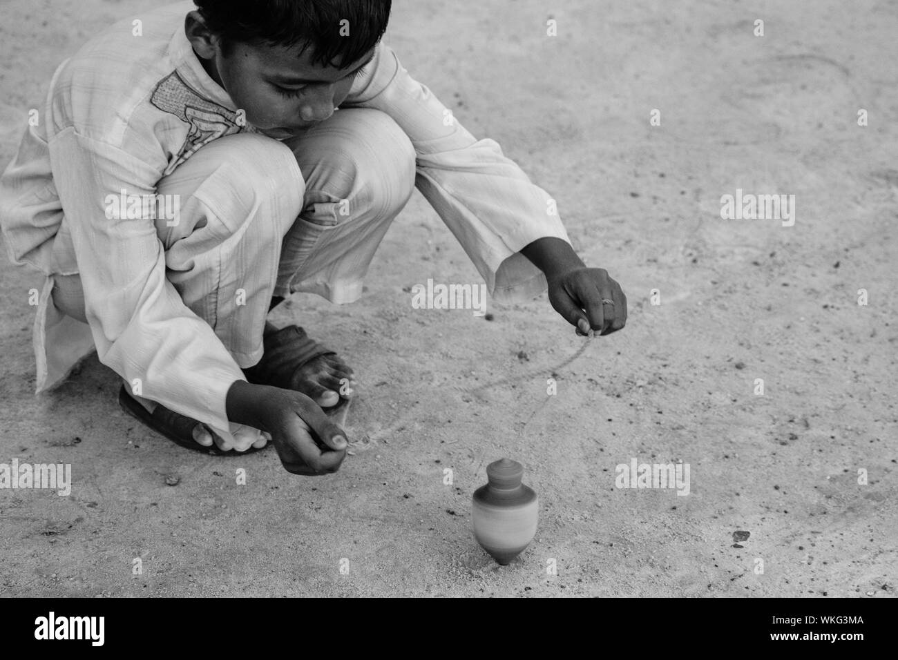 Boy playing spinning top Black and White Stock Photos & Images - Alamy