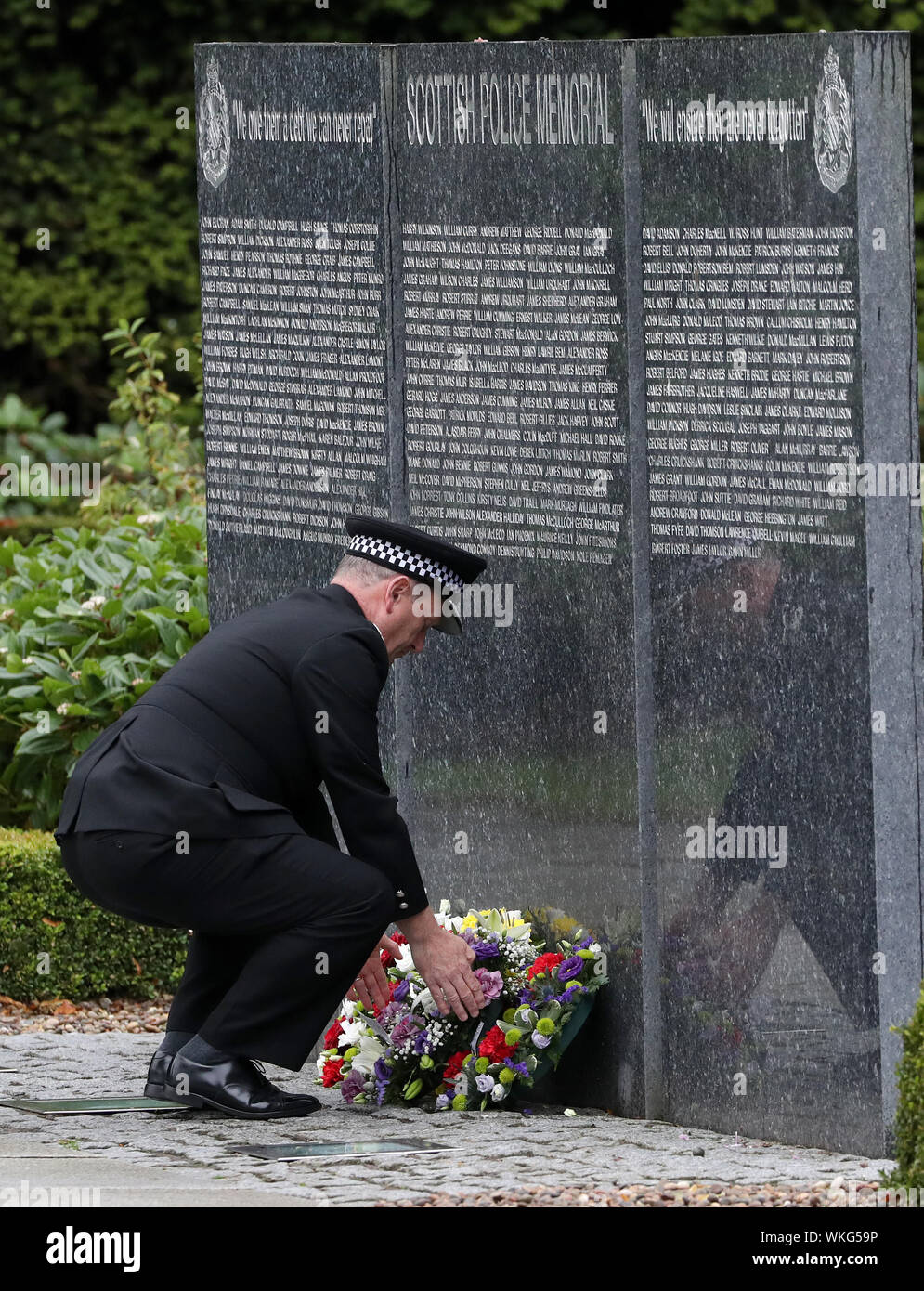 Police Scotland Chief Constable Iain Livingstone lays a wreath as he ...
