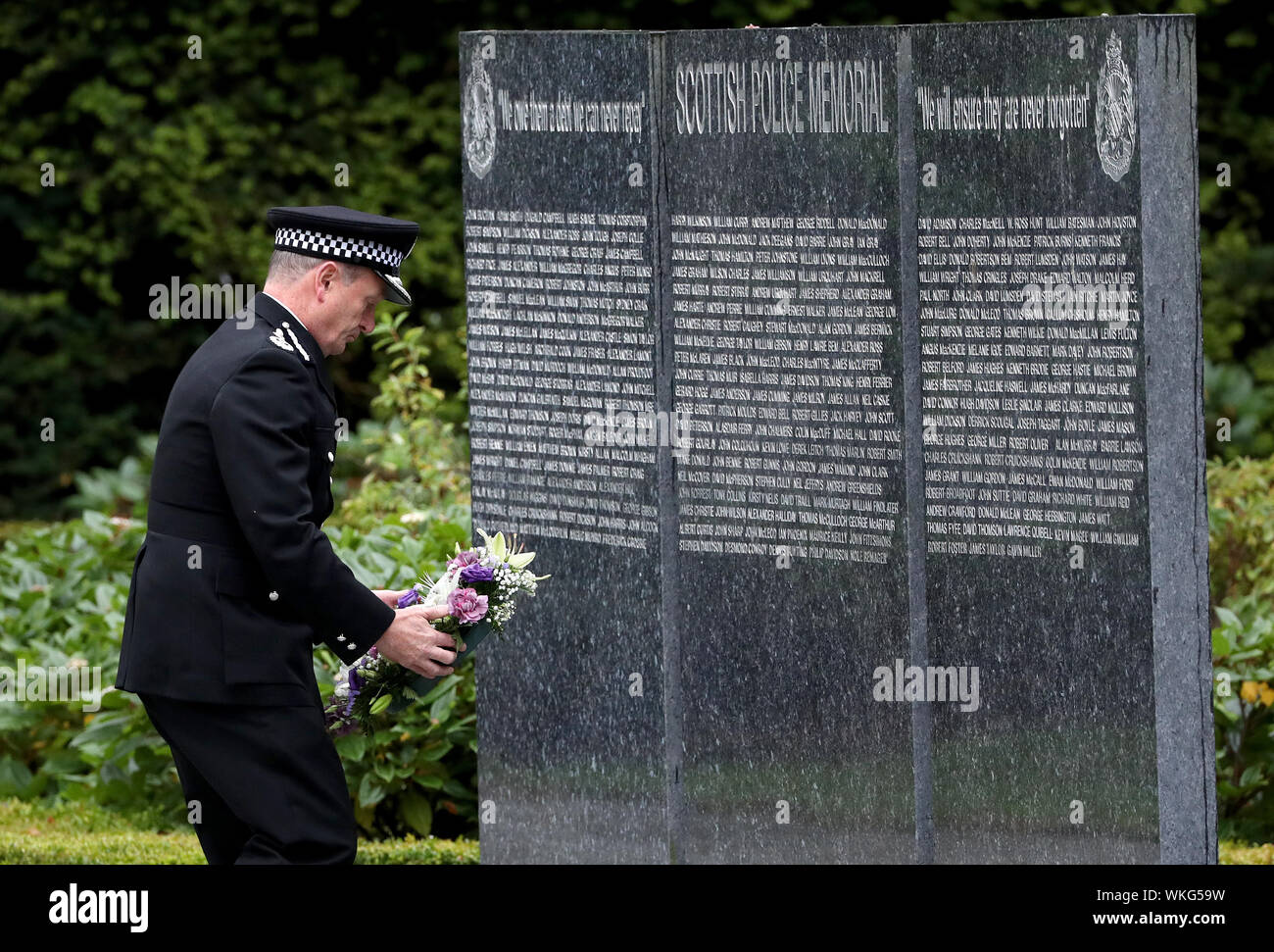 Police Scotland Chief Constable Iain Livingstone lays a wreath as he ...