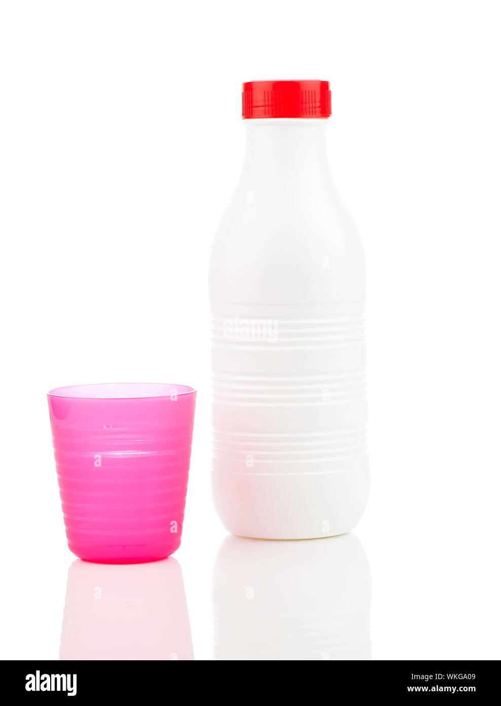 Milk bottle and plastic beaker isolated on white background Stock Photo ...