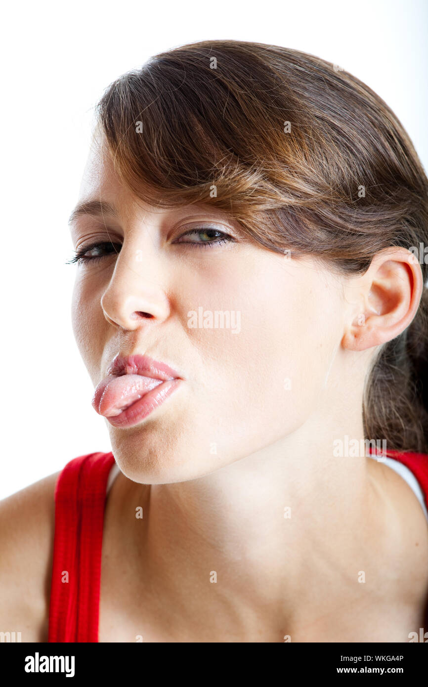 Portrait of a beautiful young woman pulling her tongue out Stock Photo ...