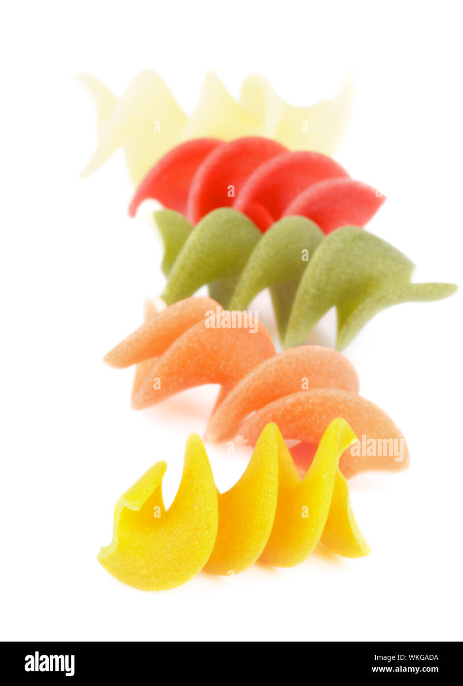 Raw Colorful Rotini Pasta In a Row isolated on white background Stock ...