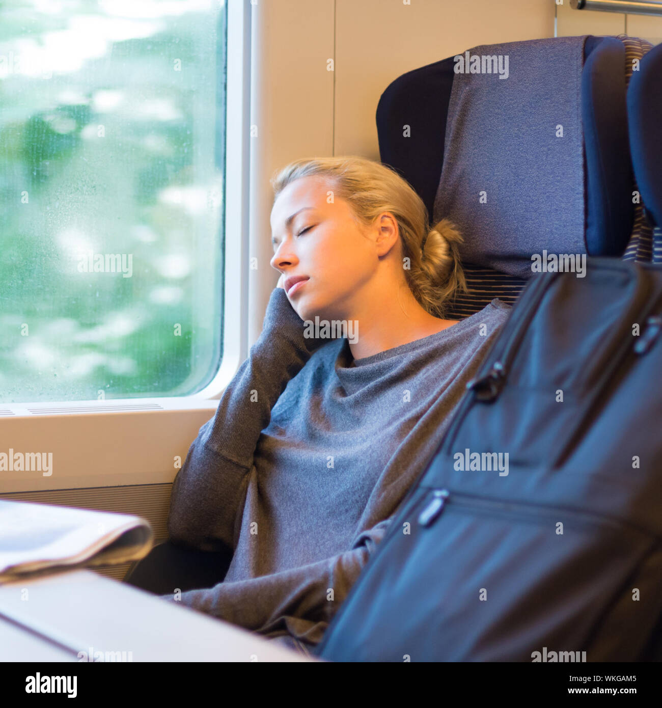 Lady traveling napping on a train Stock Photo - Alamy