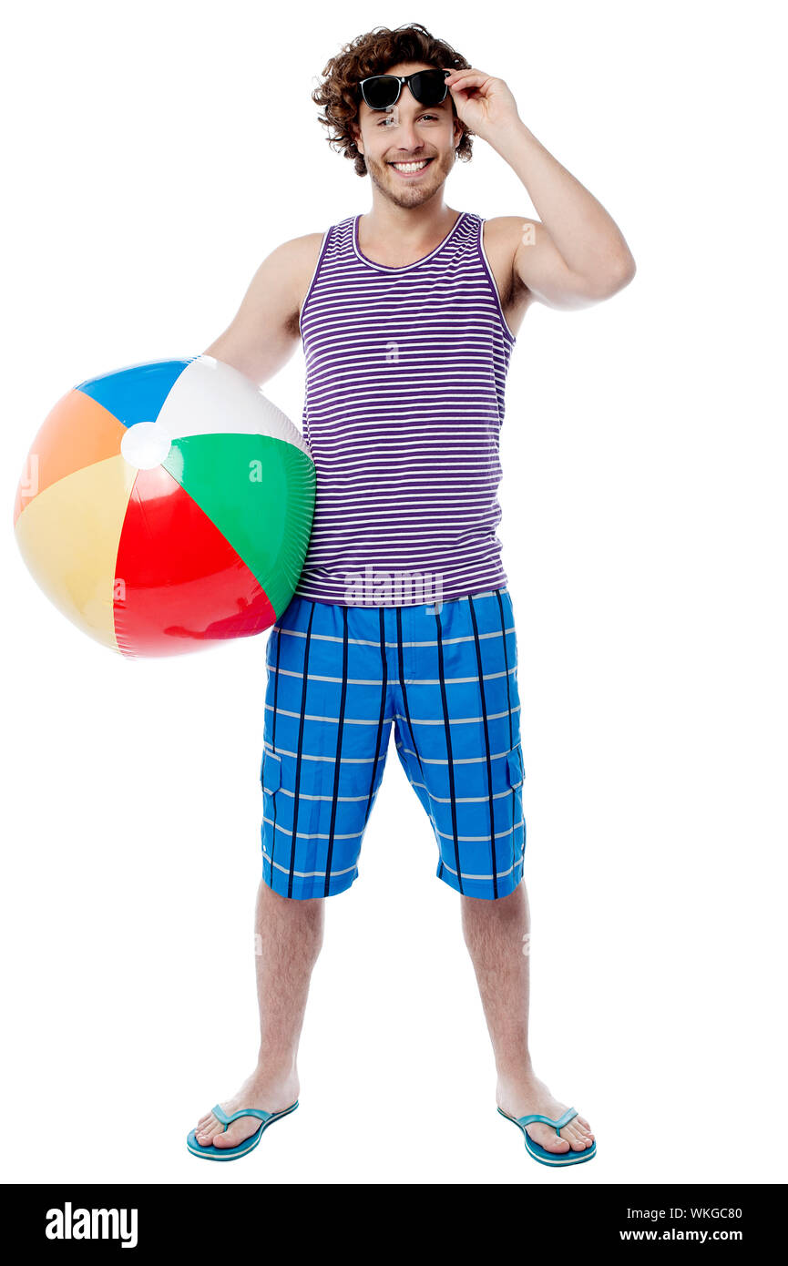 Handsome young guy holding a beach ball Stock Photo - Alamy