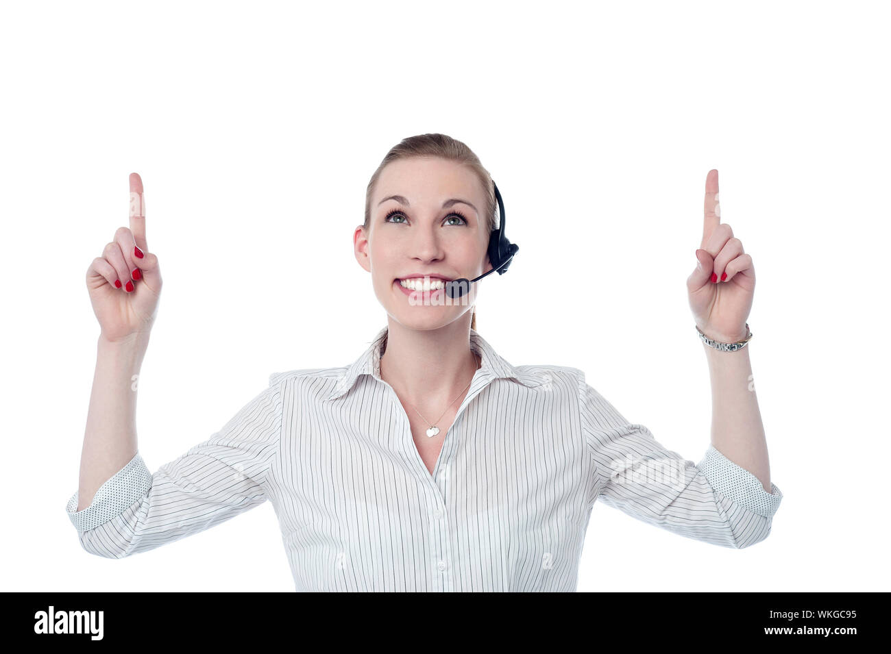 Jubilant call center woman pointing and looking up Stock Photo - Alamy