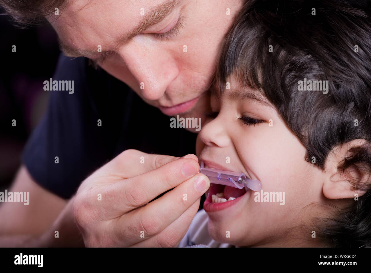 Father helping his disabled son Stock Photo - Alamy