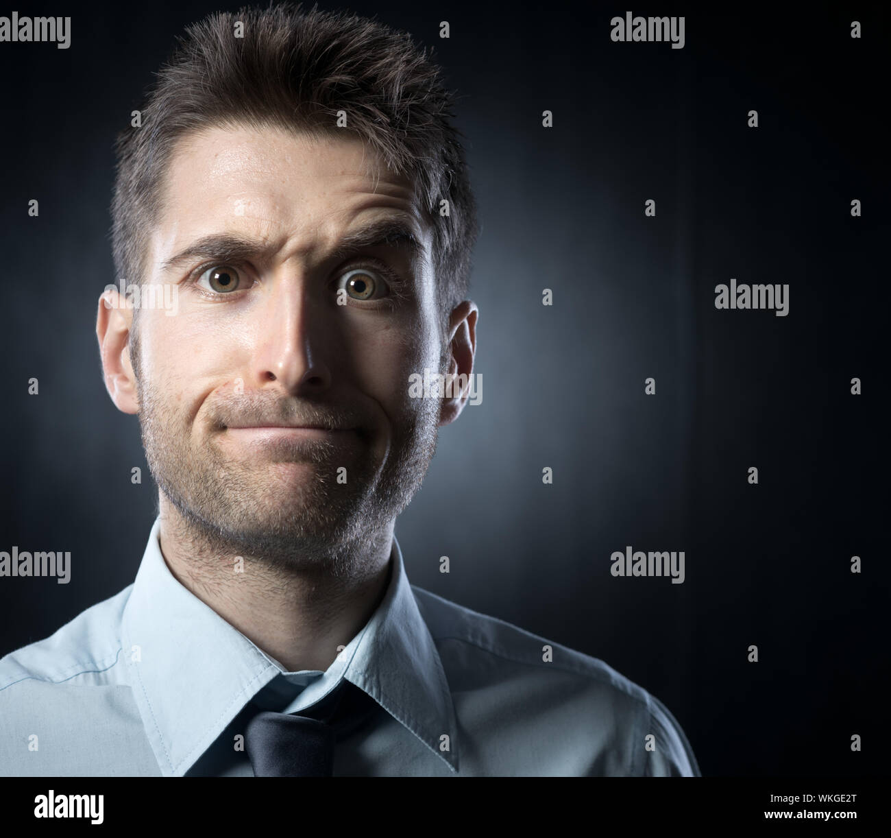 Young businessman with raised eyebrow and doubtful expression Stock ...