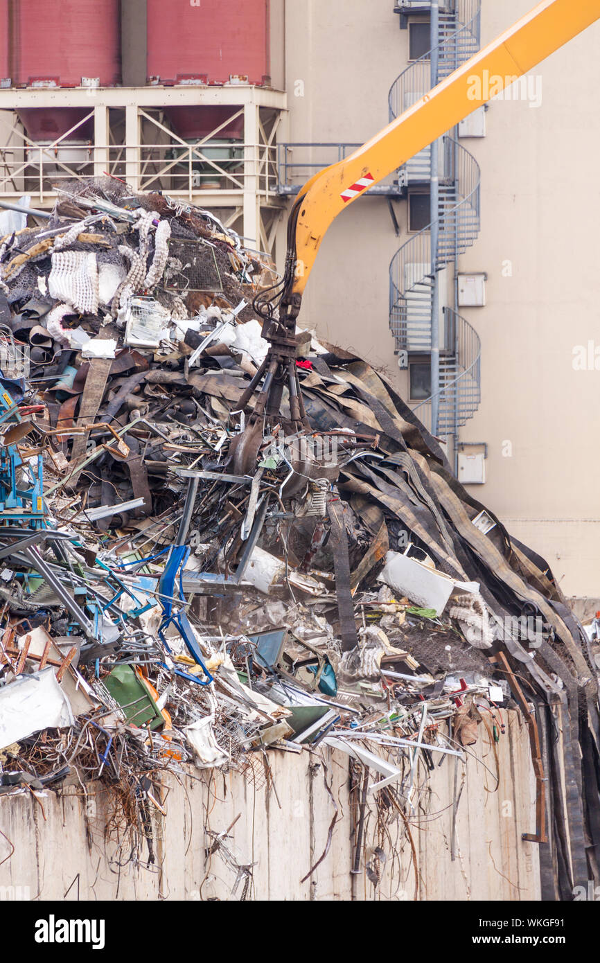 Open barge being loaded or offloaded at a wharf on an urban waterway or ...