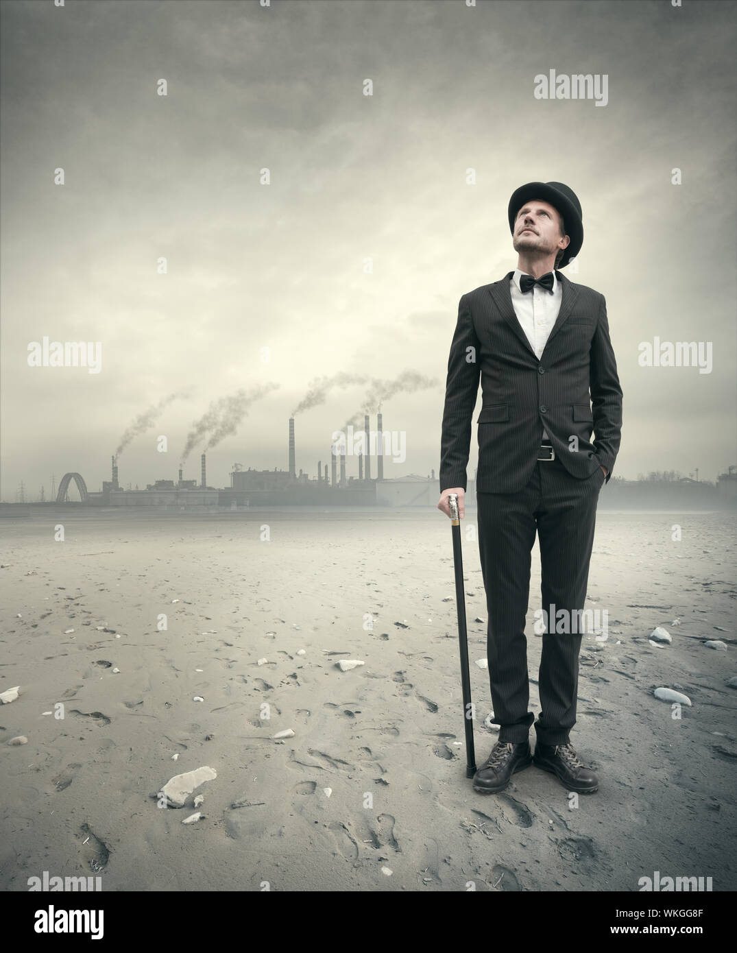 Vintage businessman looking away with polluting factory and post atomic ...