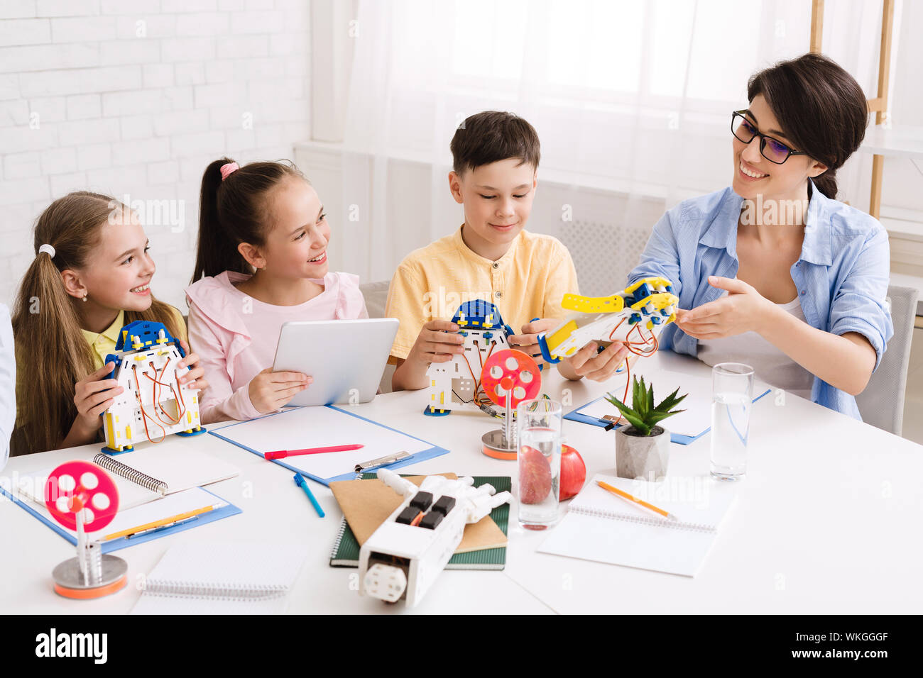 Children creating robots with teacher in classroom at stem lesson Stock ...