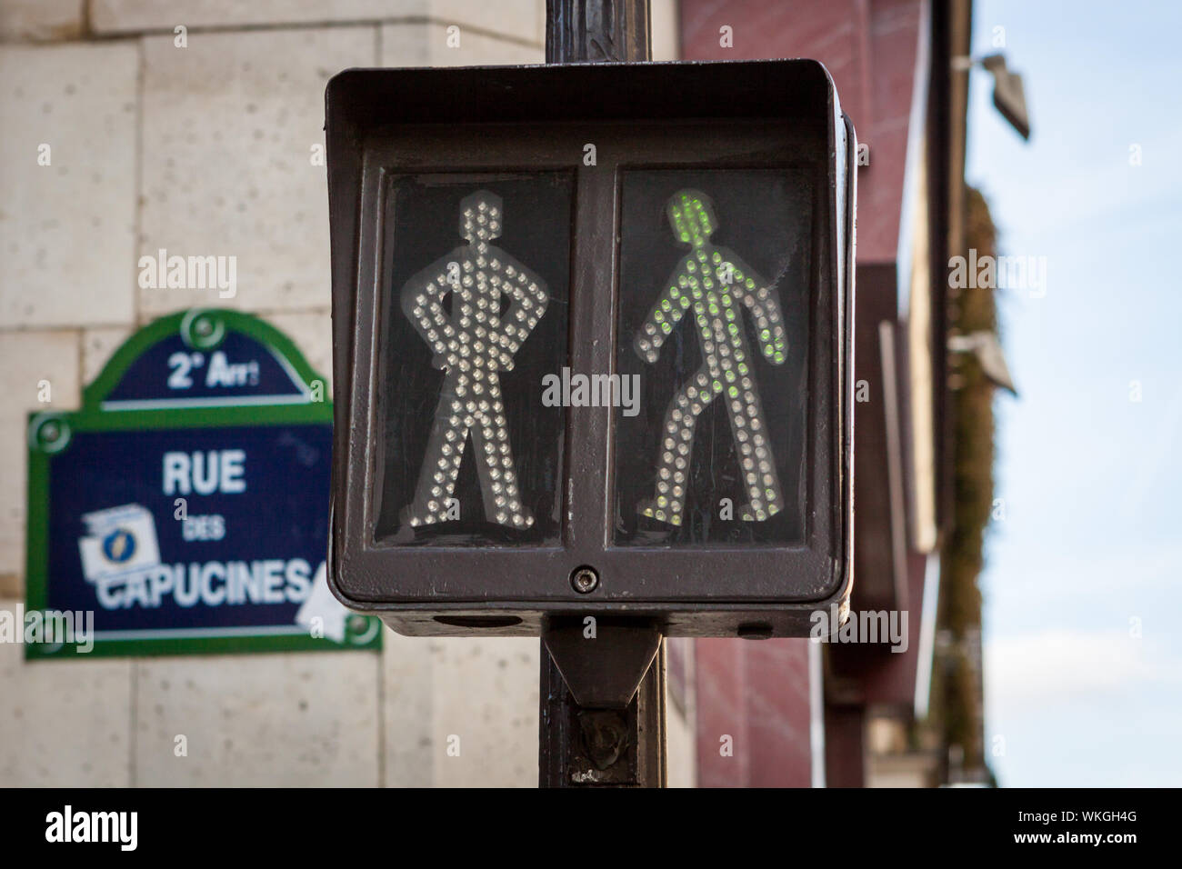 Pedestrian traffic lights at an intersection showing a figure standing ...