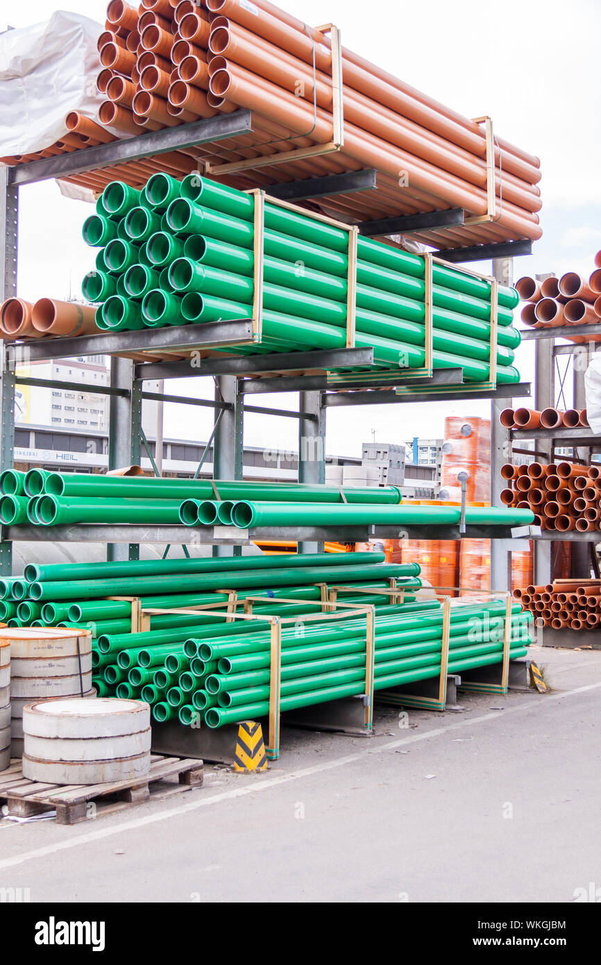 Plastic pipes stacked in a factory or warehouse yard for use in ...