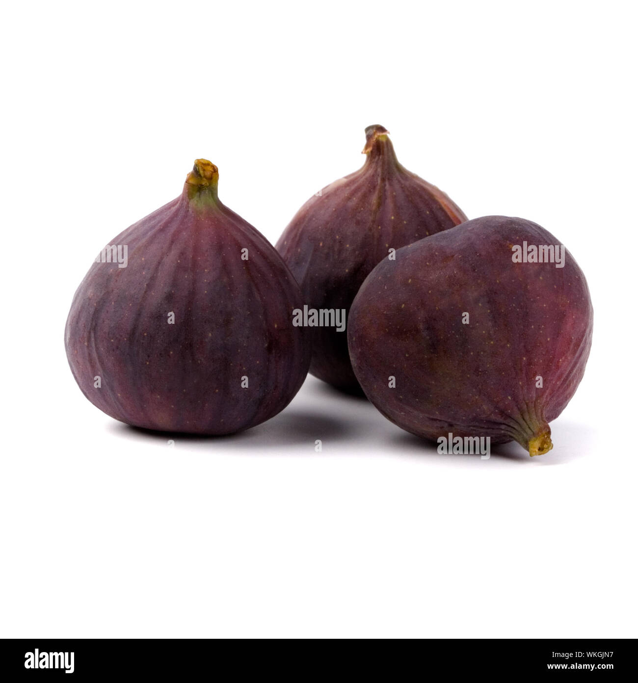three fresh figs isolated on white background Stock Photo - Alamy