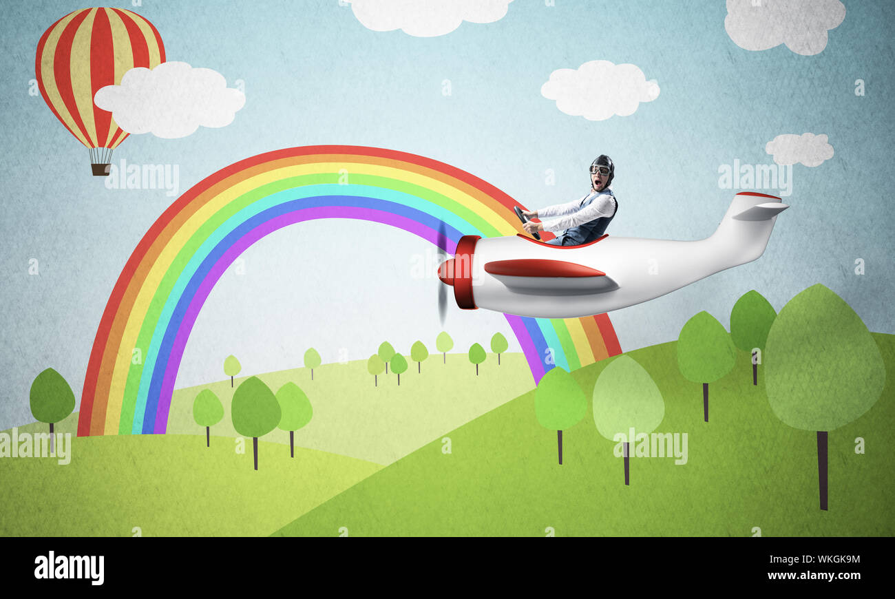 Aviator driving small propeller plane on background of nature landscape ...