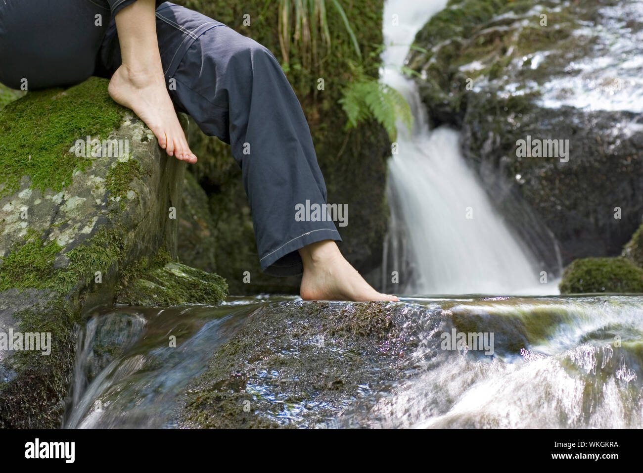 Sitting by a waterfall Stock Photo - Alamy