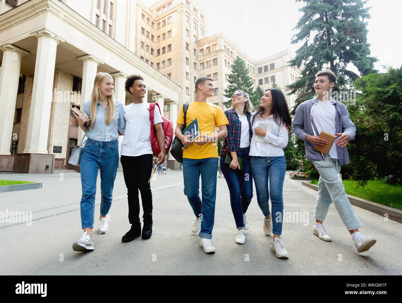 Free time of students. Friendly students walking after classes Stock ...