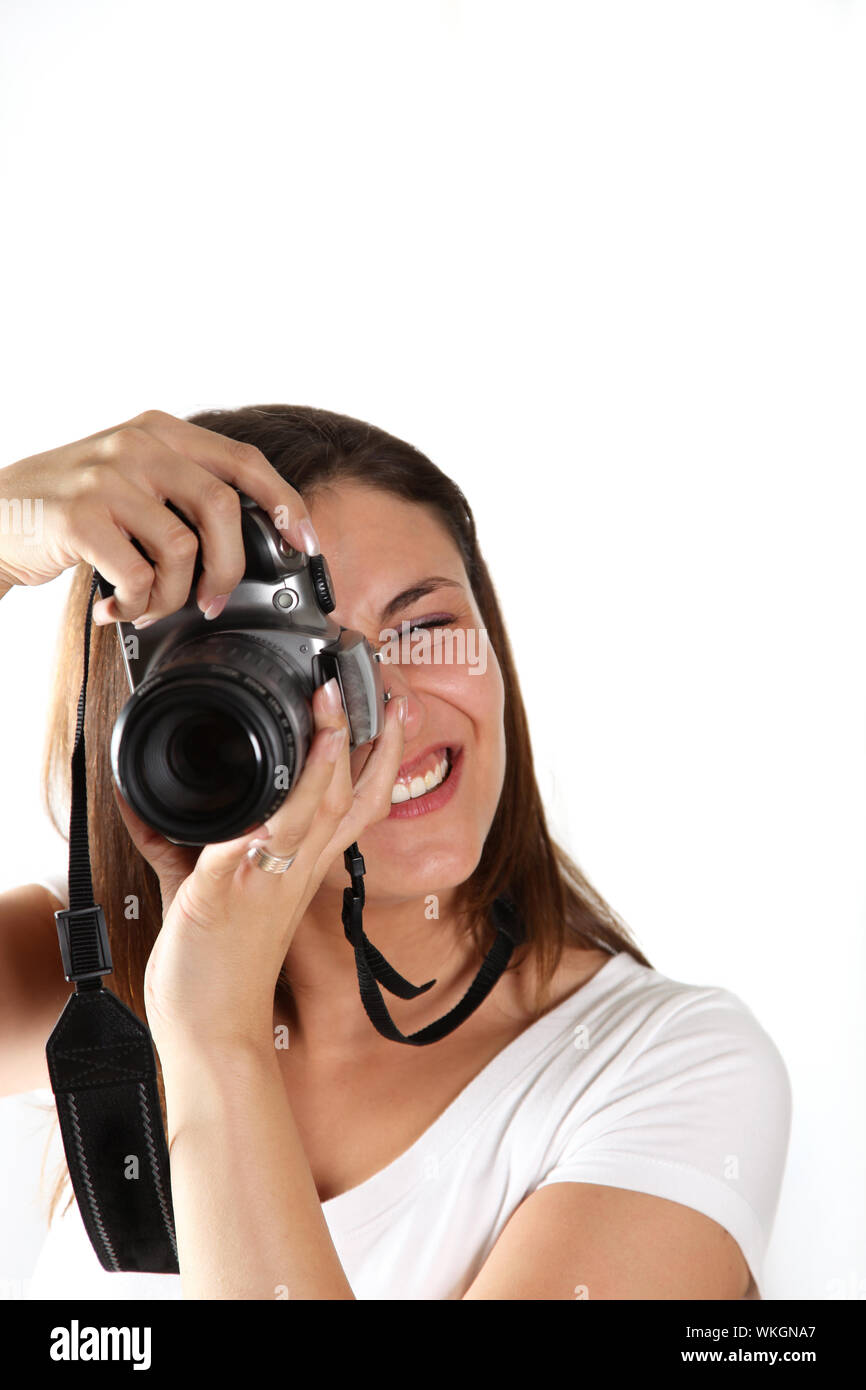 A young photographer shooting in the direction of the camera - in front ...