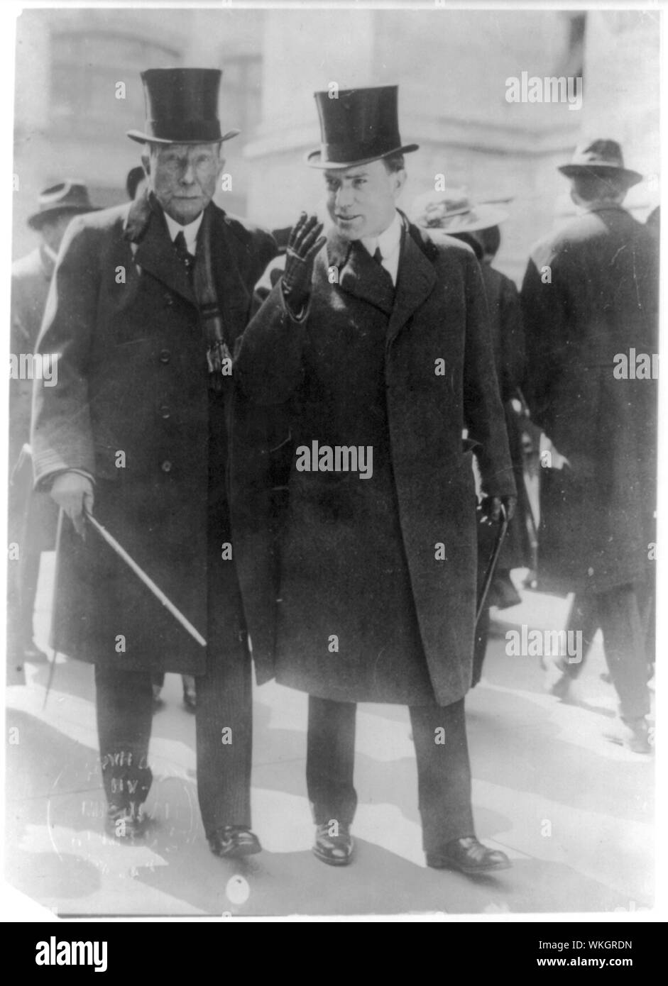 John D. Rockefeller, full-length portrait, walking on street with John ...