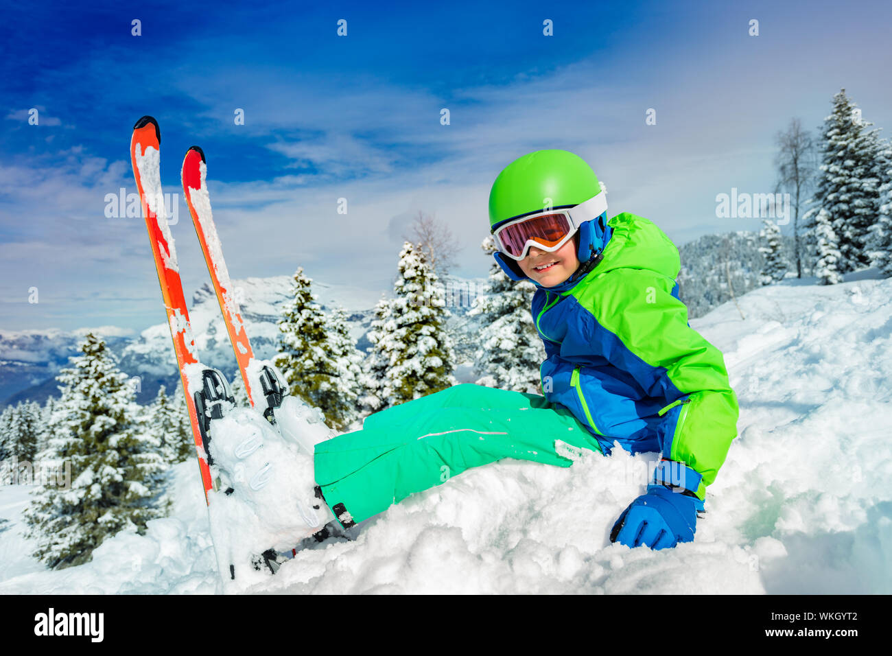 Boy wear ski mask and helmet smile, rest in snow Stock Photo - Alamy