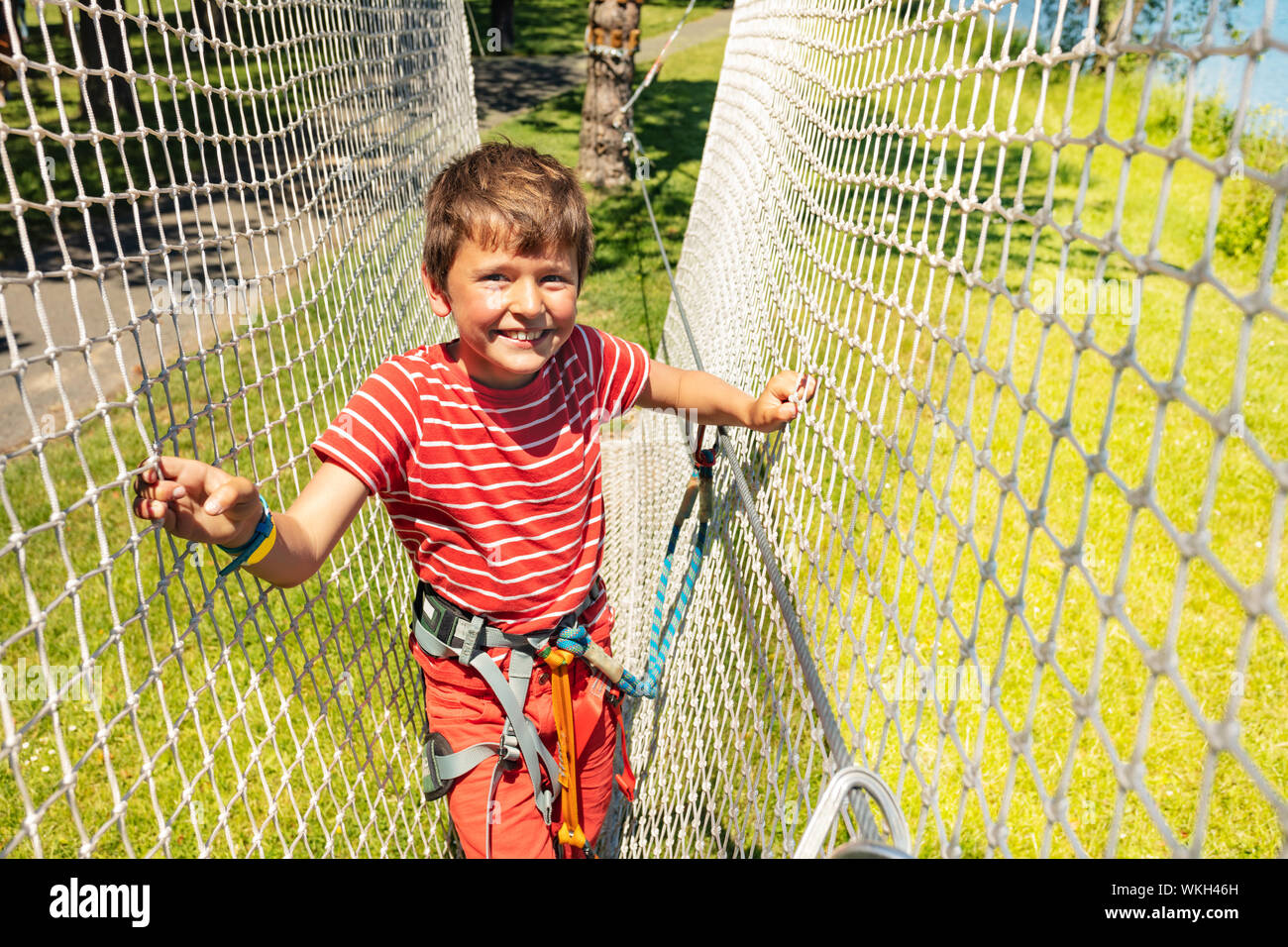 Boy in the net on rope climbing playground park Stock Photo - Alamy