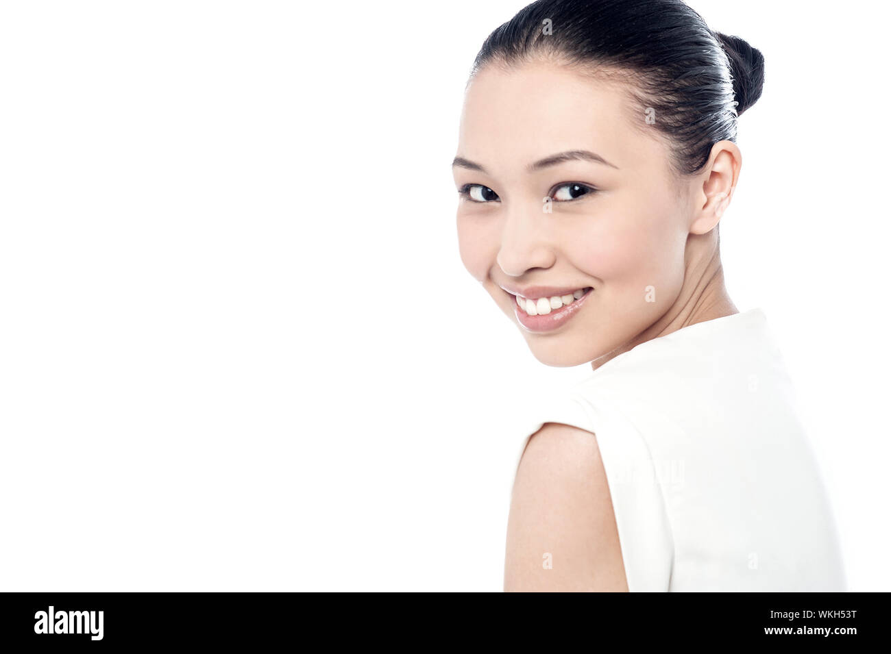 Smiling pretty woman turning her head over her shoulder Stock Photo - Alamy