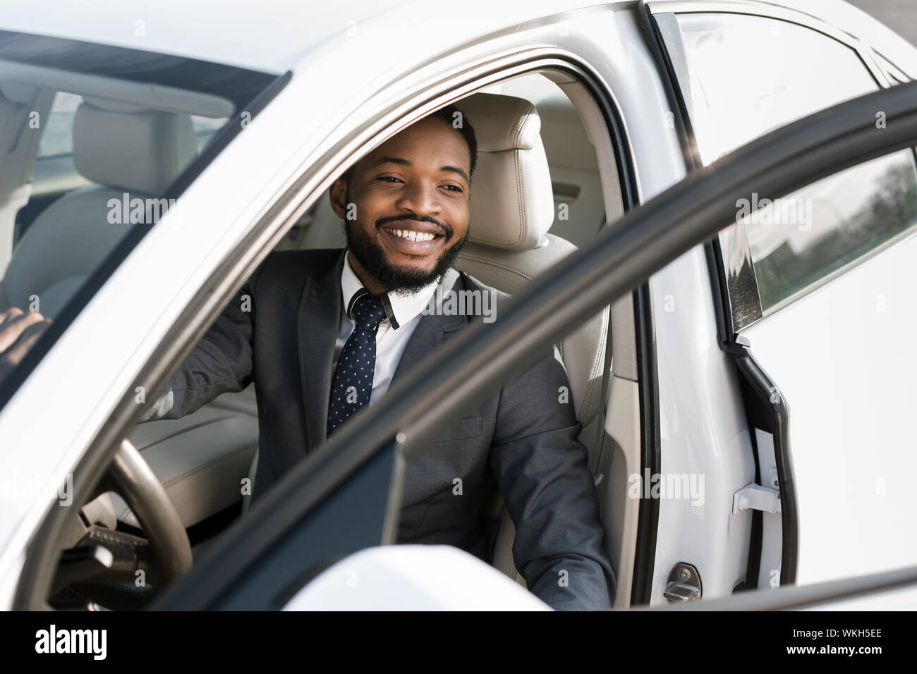 Young businessman getting out car hi-res stock photography and images ...