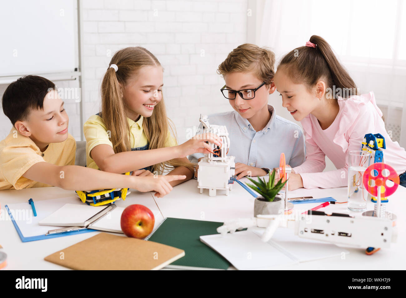 Happy children creating robots at stem class Stock Photo - Alamy