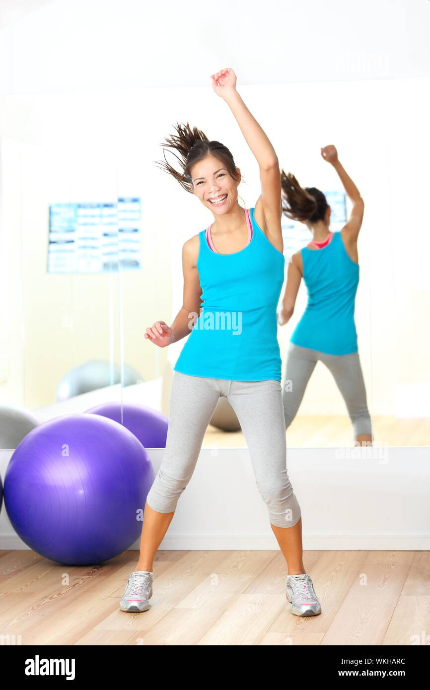 Gym aerobics zumba fitness dance instructor. Woman dancing happy in ...