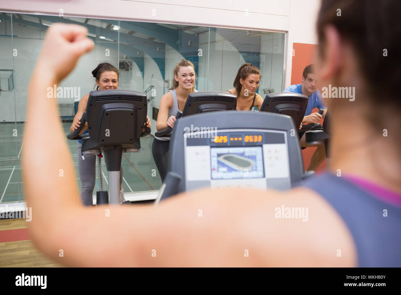 Happy people at spinning class in gym with instructor Stock Photo - Alamy