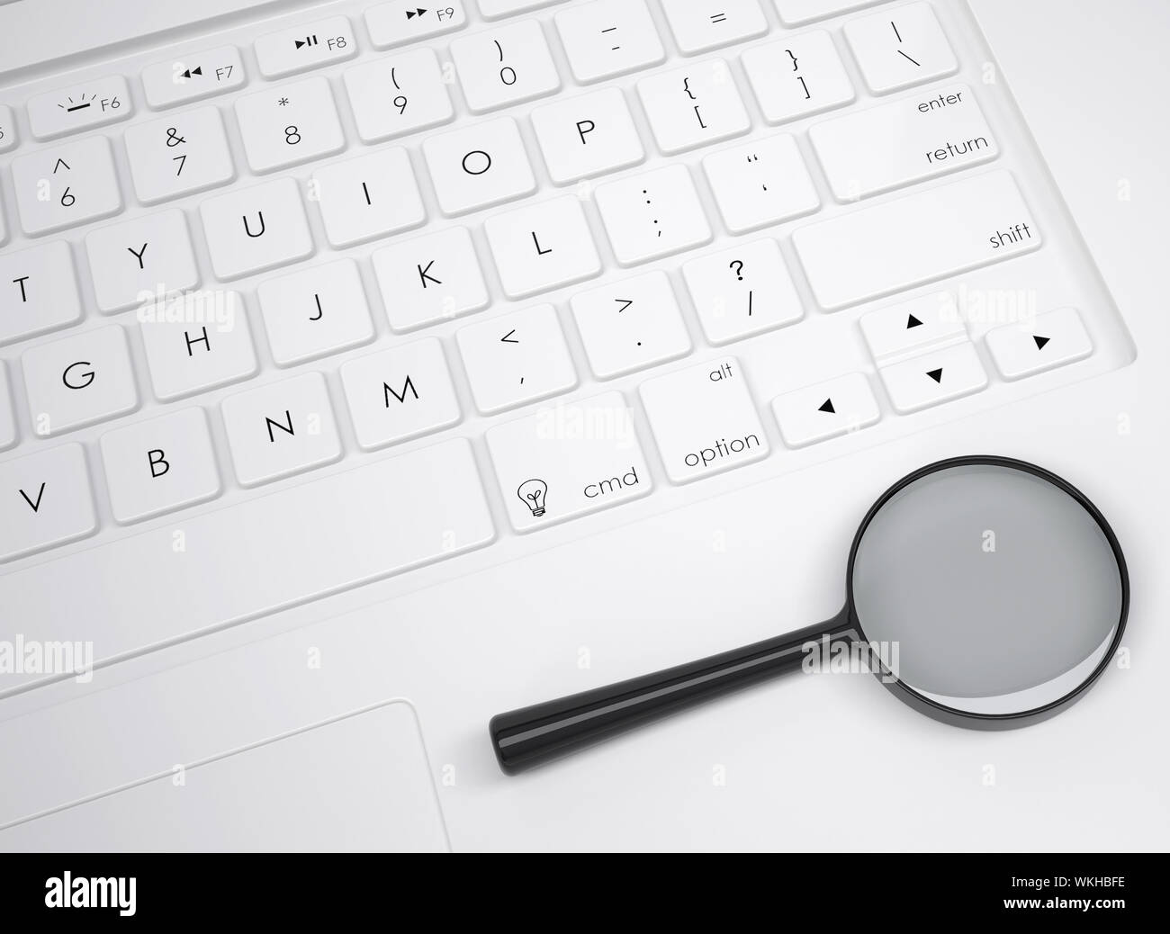Magnifier glass on the keyboard. View from above Stock Photo - Alamy