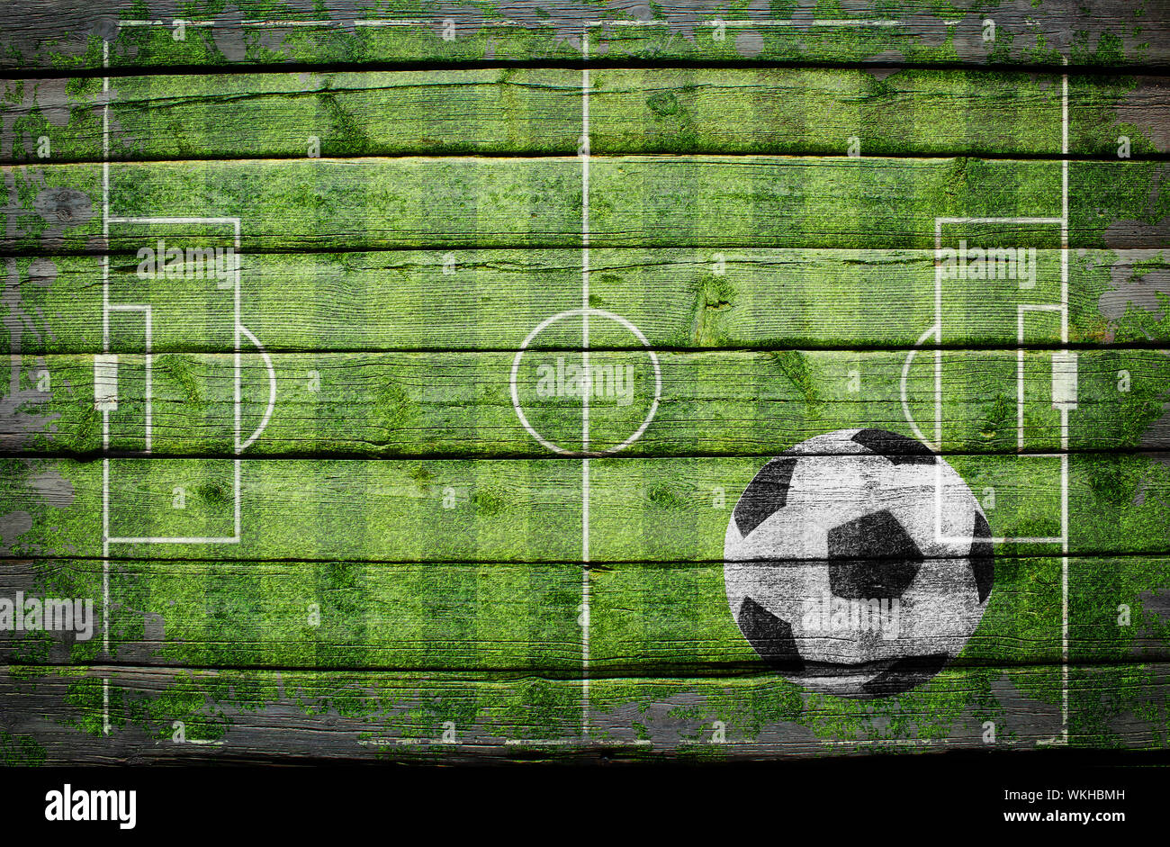 Soccer ball on wooden surface. Football field is marked with guides ...